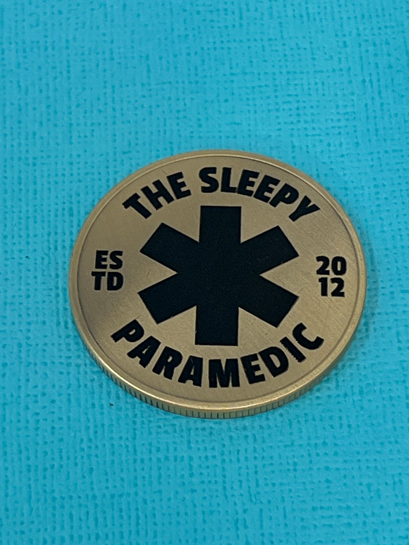 SLEEPY PARAMEDIC CHALLENGE COIN – TRACER MOUNTAIN ENGRAVING